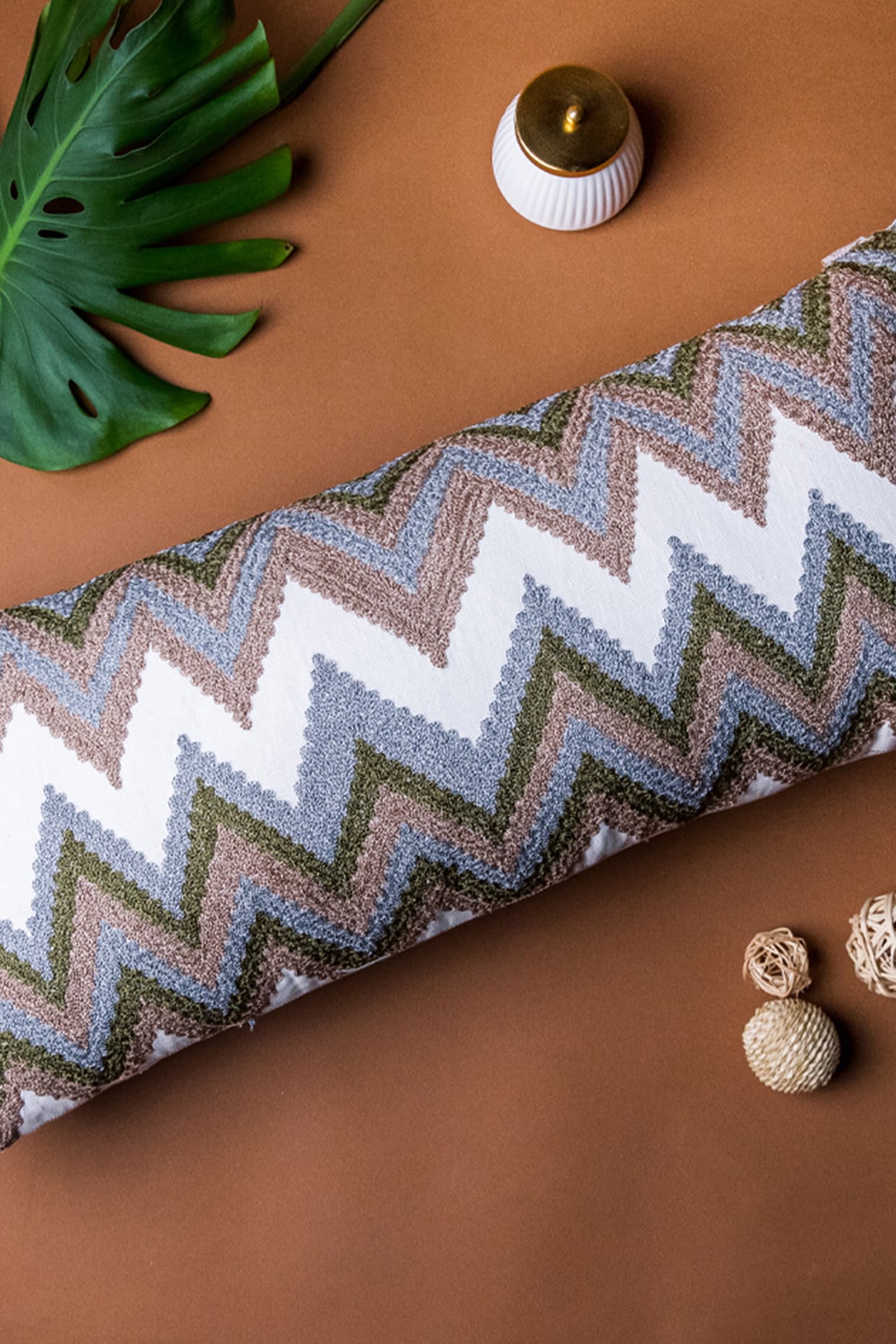 Off-White Dual Chevron Aari Cushion Cover by ALCOVE at Pernia's Pop Up ...