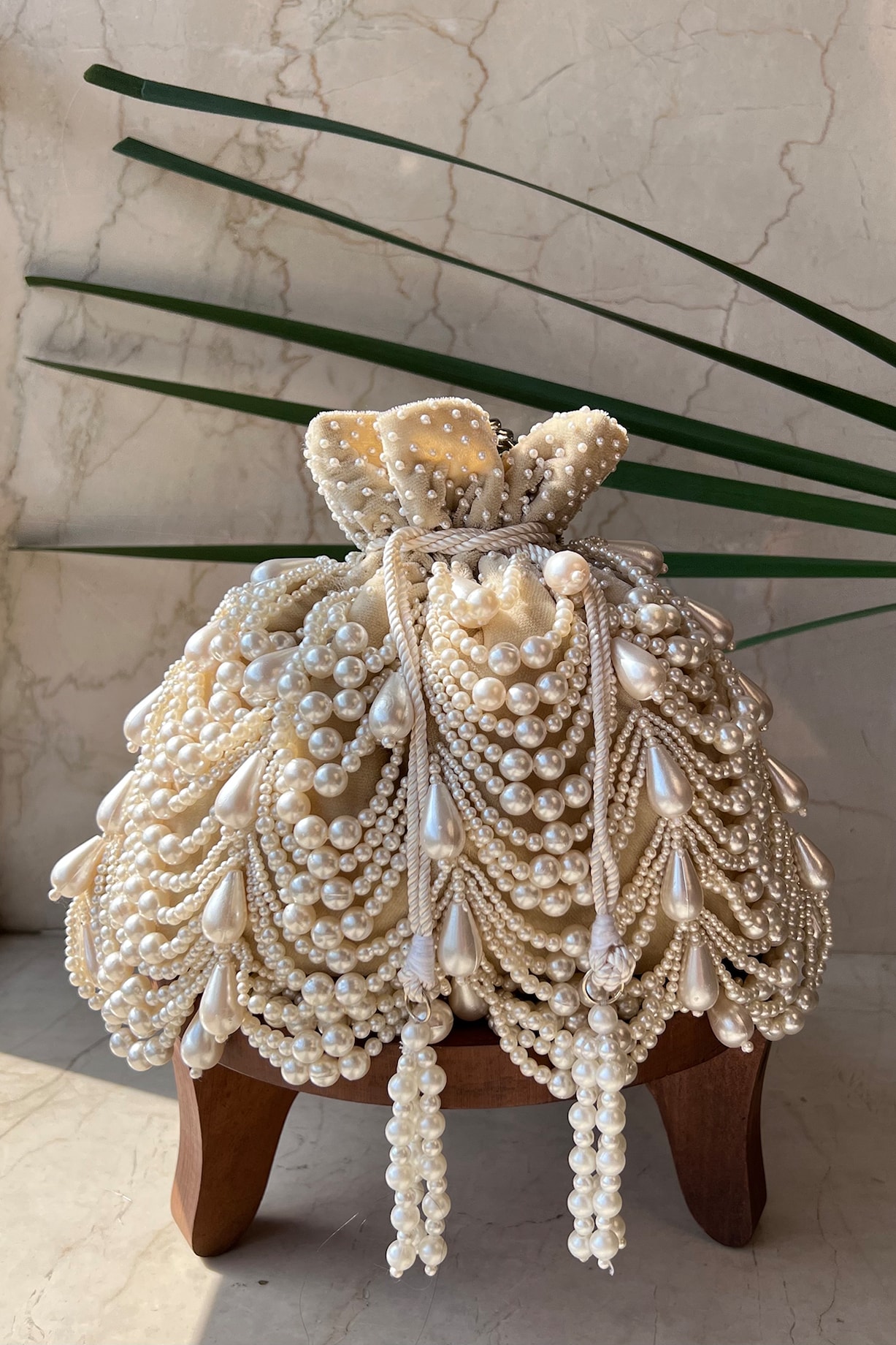 Ivory Velvet Embroidered Potli by Nayaab by Sonia at Pernia's Pop Up Shop 2024