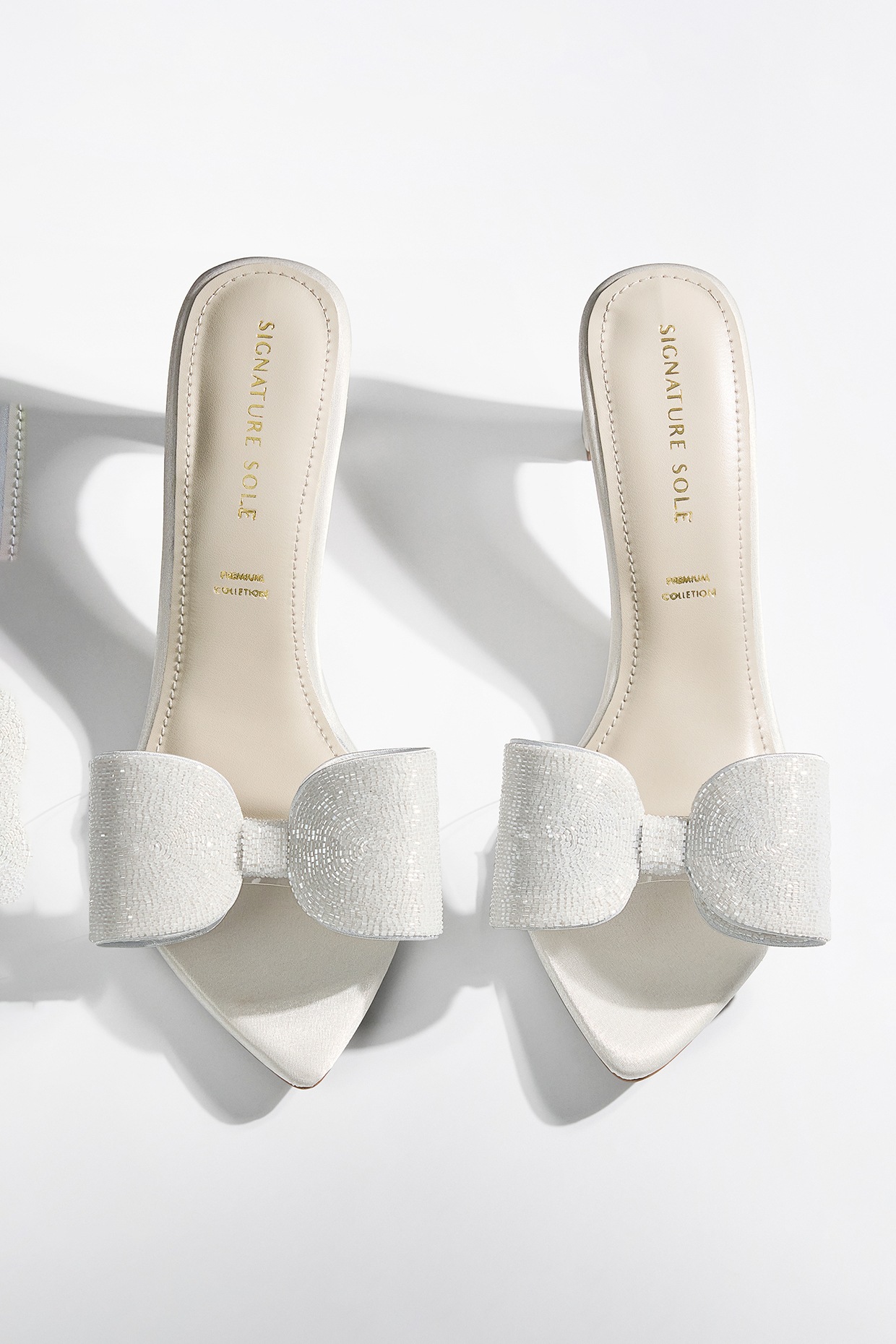 White Vegan Leather Crystal Bow Heels by Signature Sole at Pernia's Pop ...